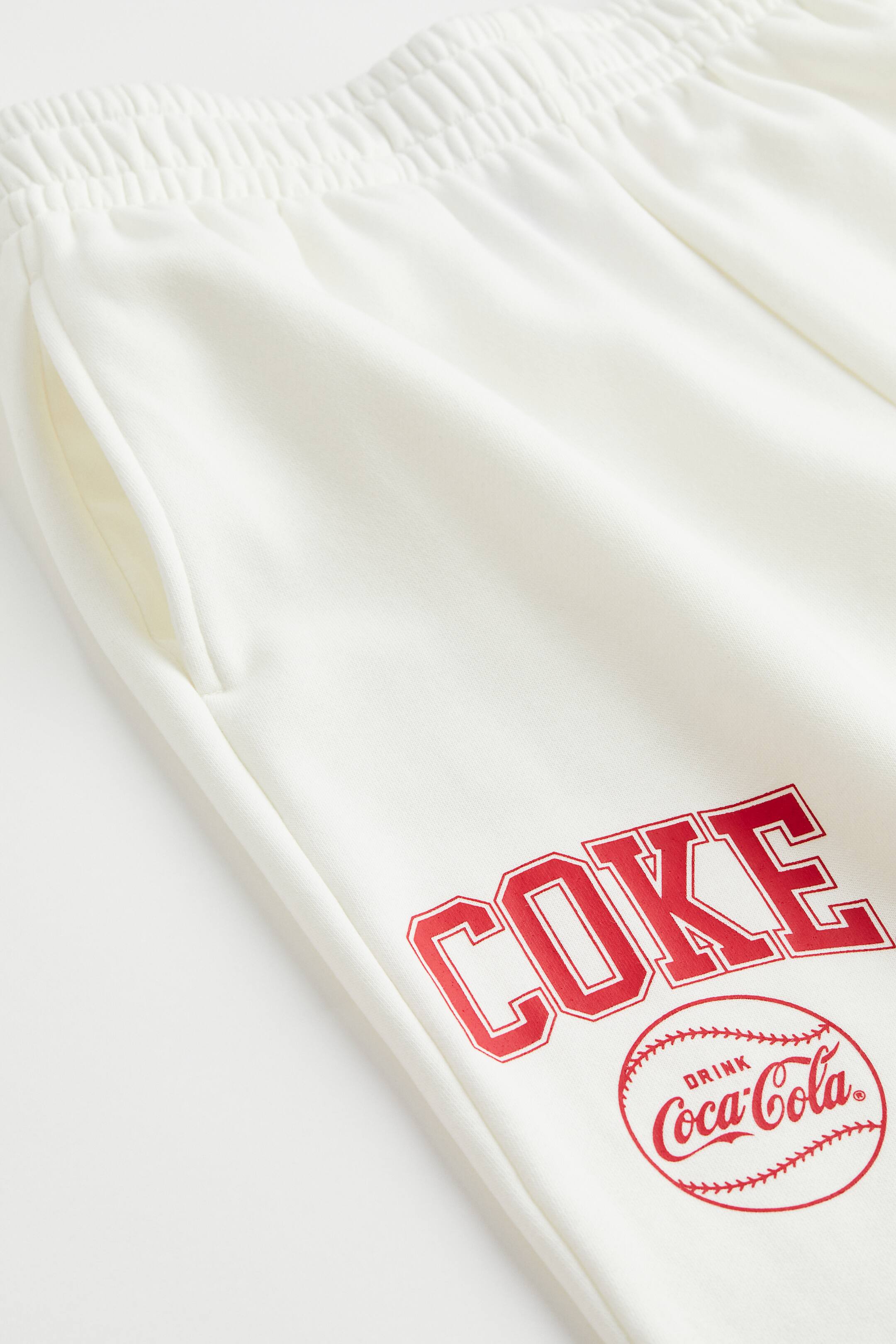 Printed joggers - White/Coca-Cola - Ladies | H&M PH