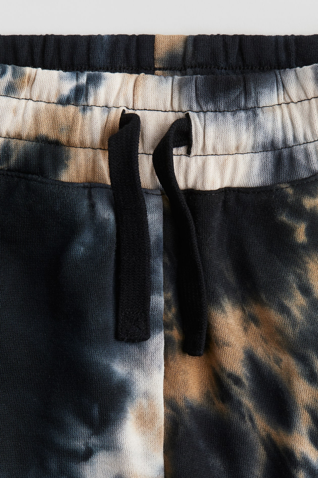 Patterned Joggers - Dark blue/tie-dye - Kids | H&M US